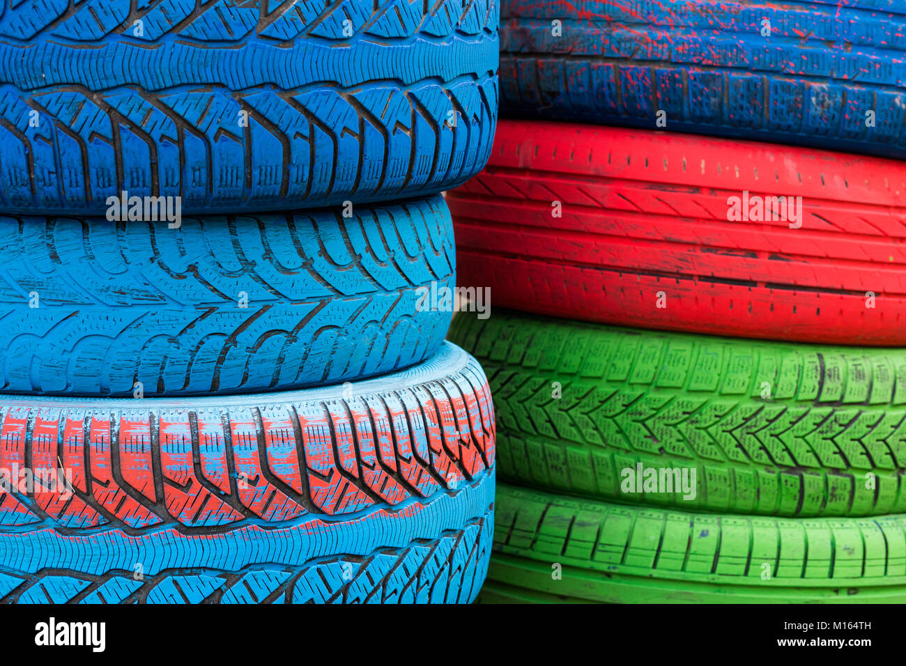 Tires painted in blue, green and red colors Stock Photo - Alamy