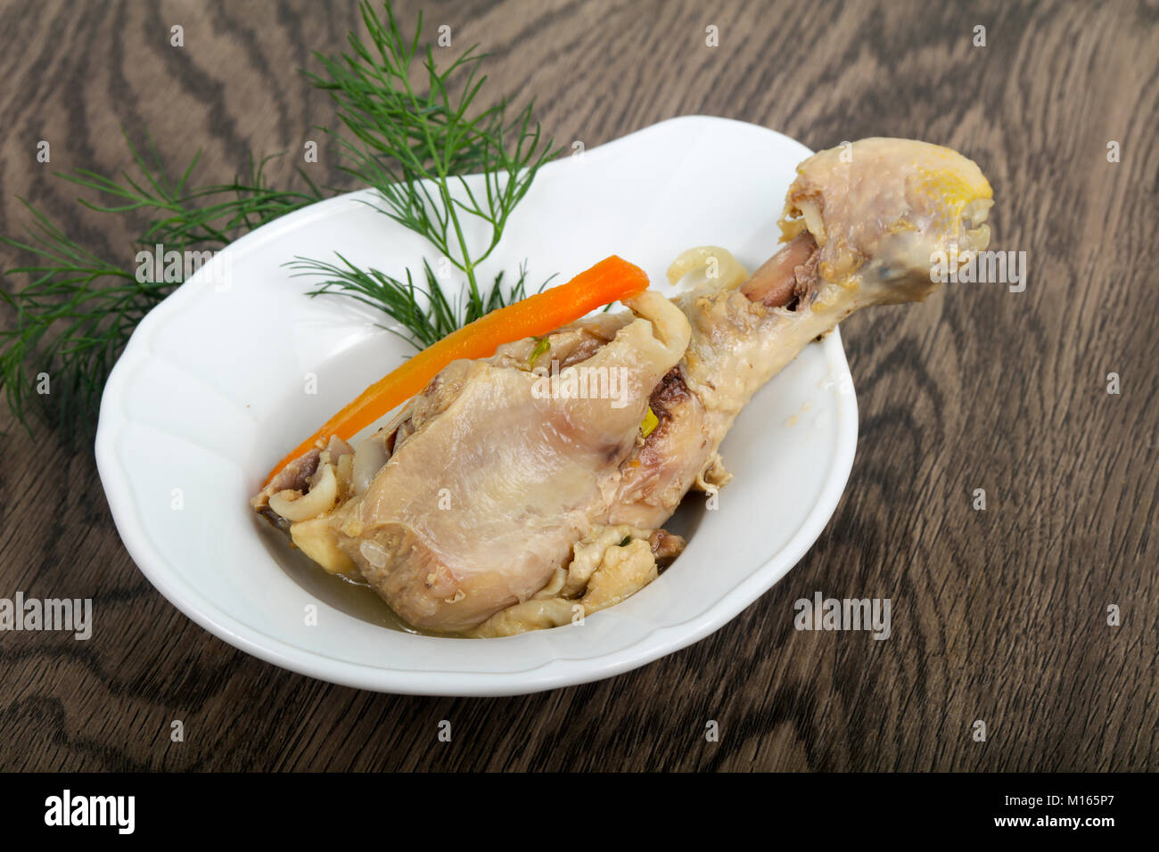 Boiled chicken leg served dill Stock Photo - Alamy