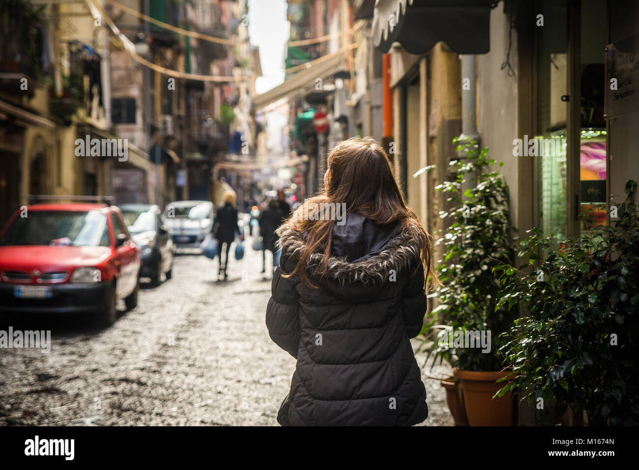 Tourist girl in Naples walking along the crowded, busy streets, Italy ...
