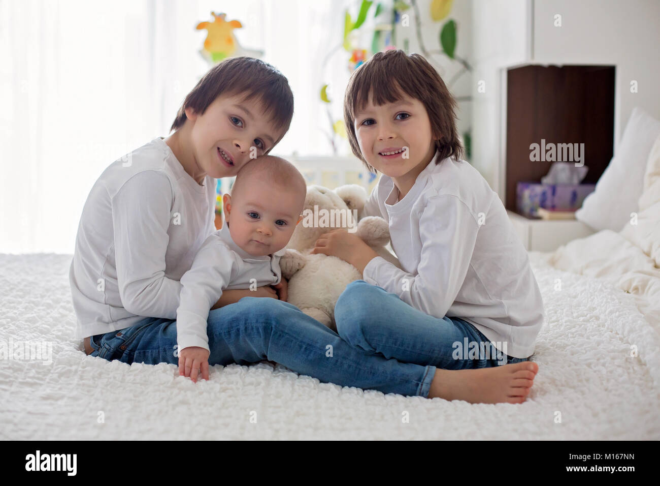 Little toddler and preschool boys, playing with their little brother at ...