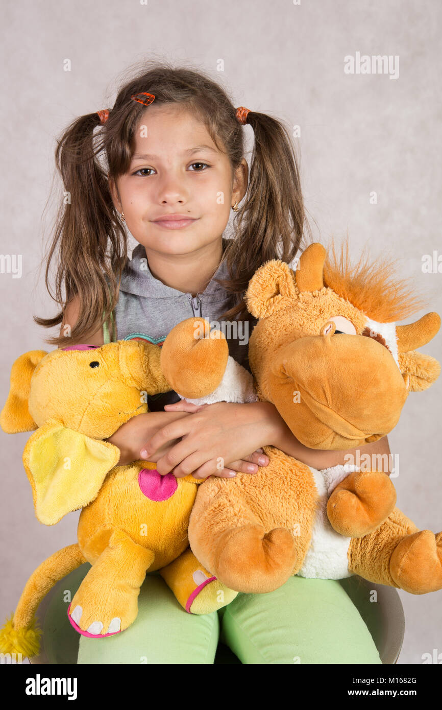 girl on white background with soft toys hugs Stock Photo - Alamy