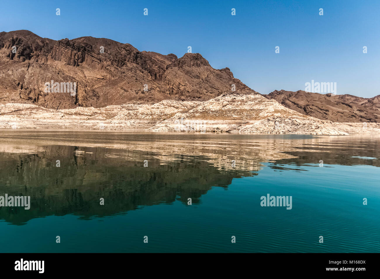Reflection in the water of the sedimentary rock formation surrounding ...