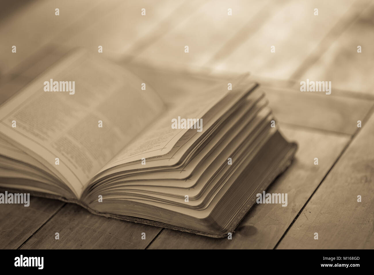 Ancient book on solid oak table Stock Photo - Alamy