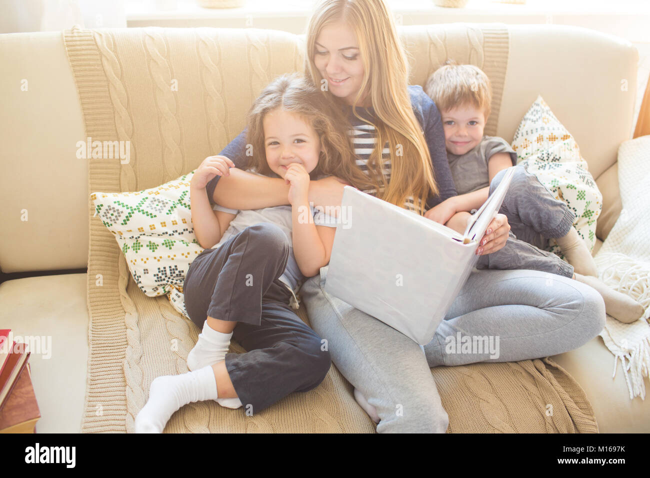 Happy family learning together. Children with books Stock Photo - Alamy