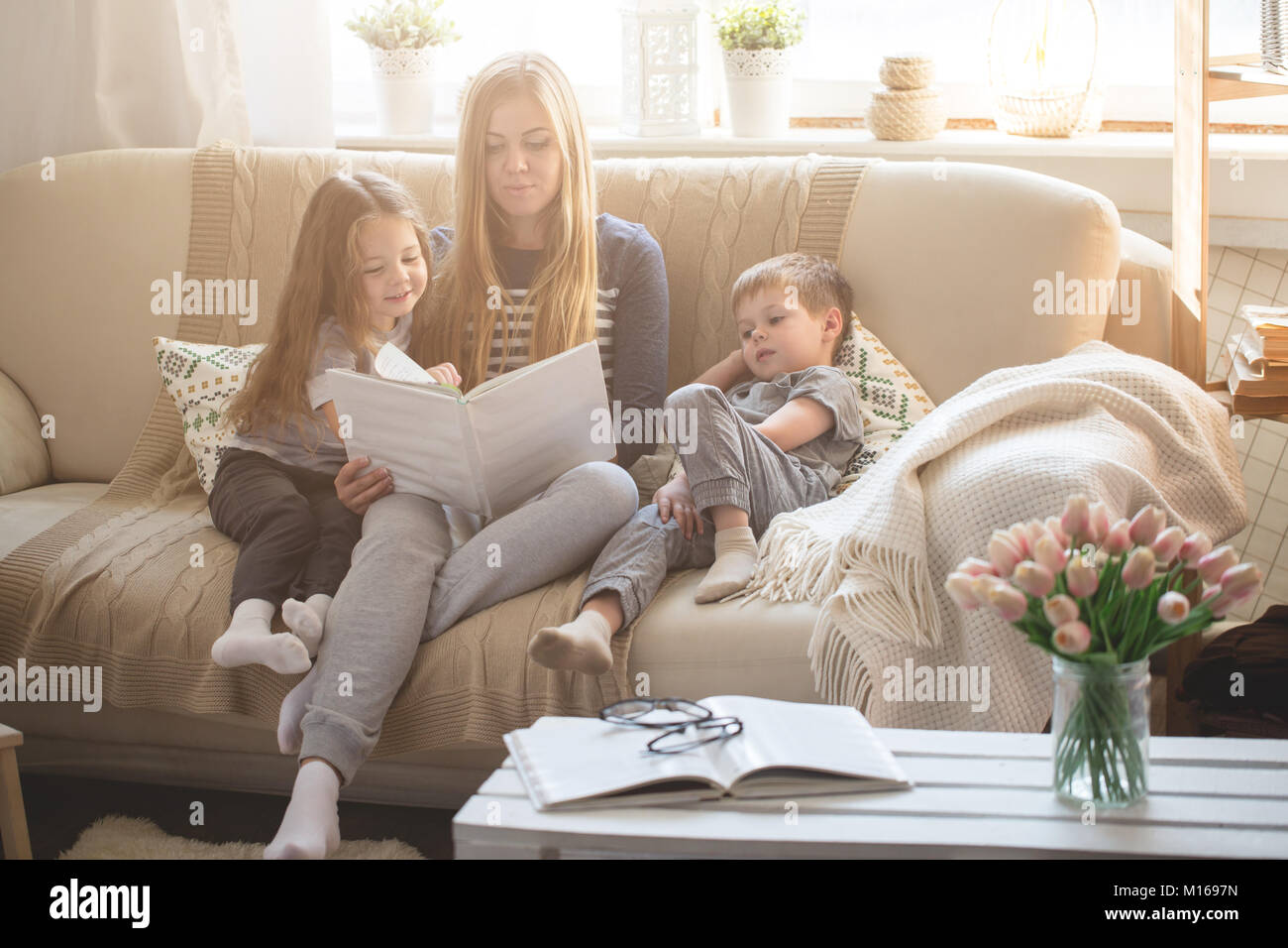 Happy family learning together. Children with books Stock Photo - Alamy