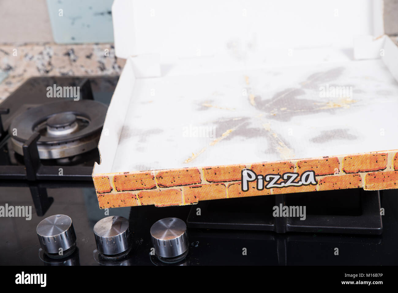 Used cardboard pizza box with grease stains lesft on its bottom Stock ...