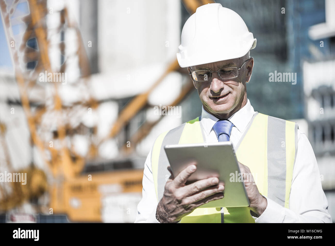 Construction manager controlling building site and tablet device Stock ...
