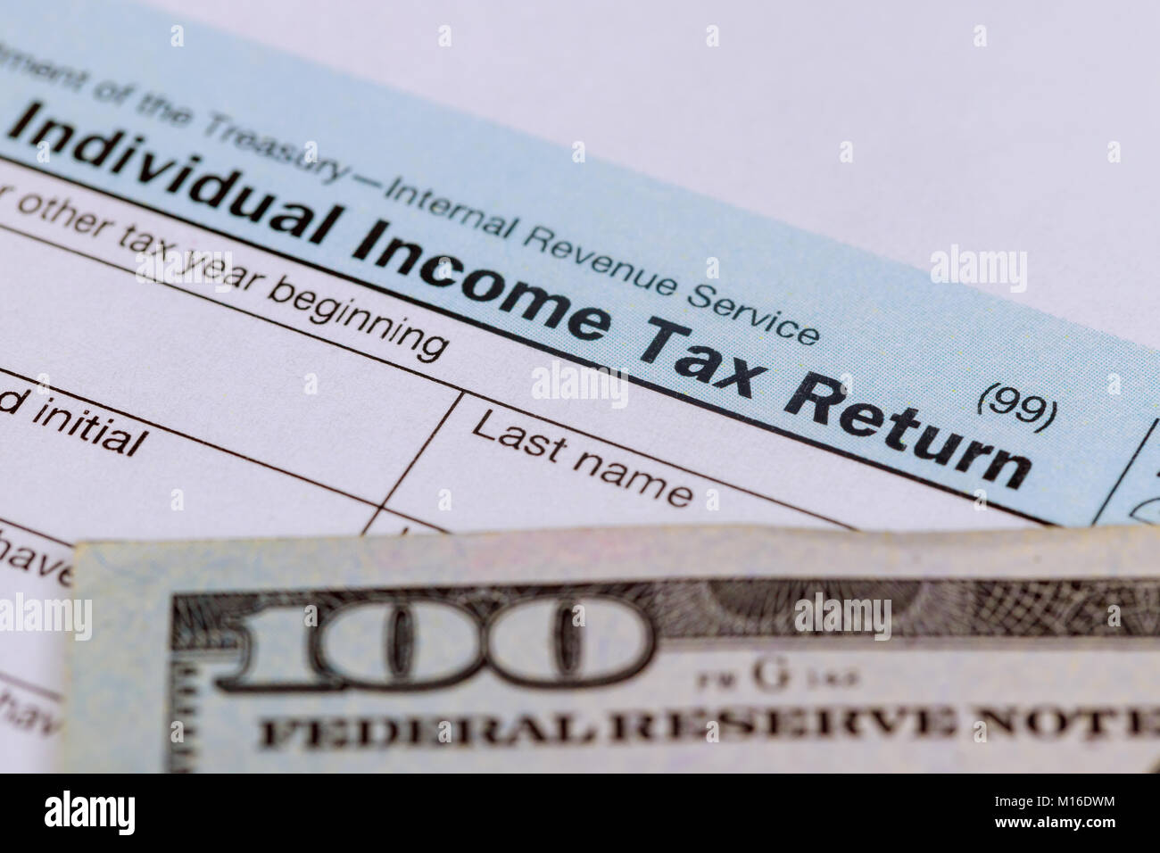 Tax time - Closeup of U.S. 1040 tax return with 100 bills pay tax Stock ...