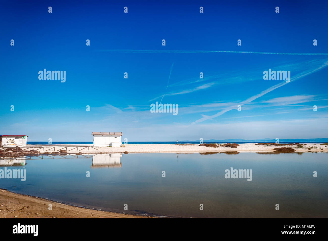 Reflection of cottage on the beach in a sunny day Stock Photo - Alamy