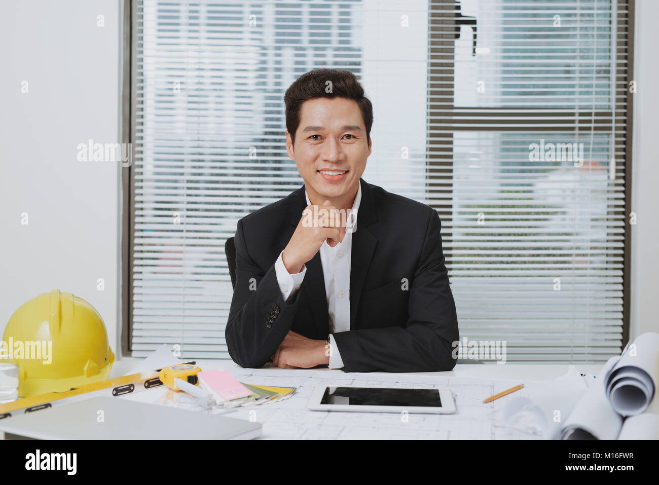 Architect - project manager working with blueprints in the office Stock ...