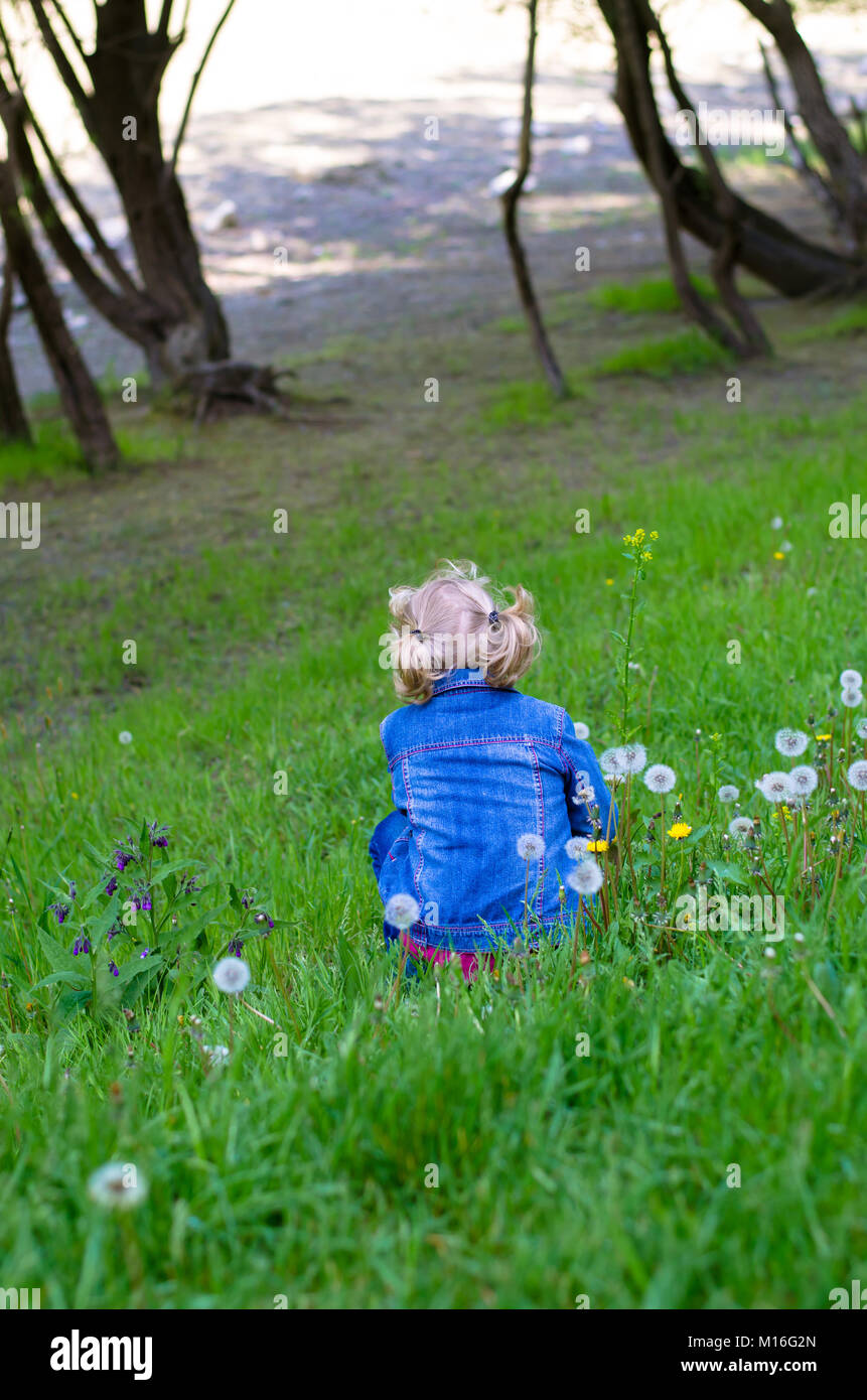 rear view of blond girl in green meadow Stock Photo - Alamy