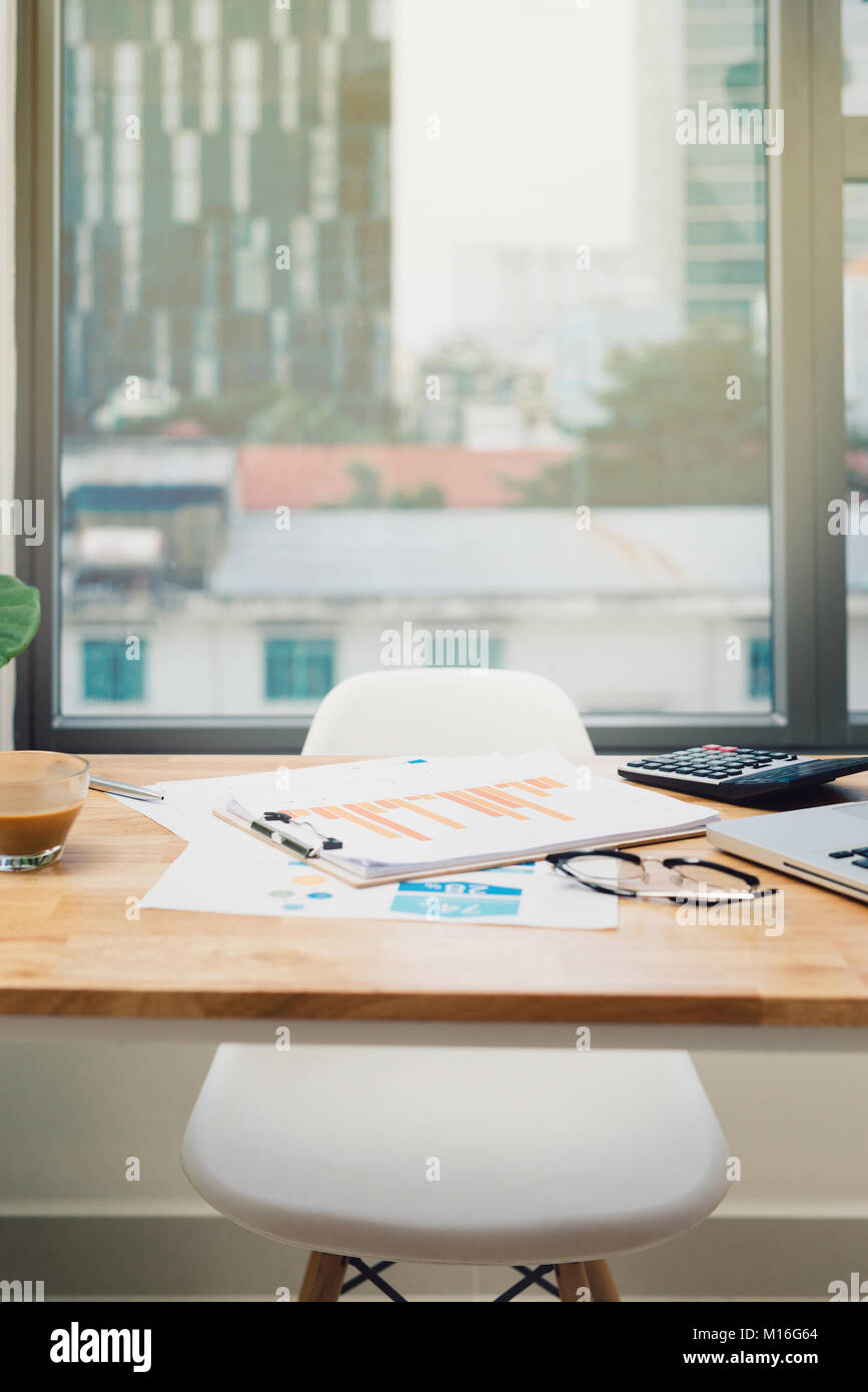 Office workplace with laptop on wood table against the windows Stock ...
