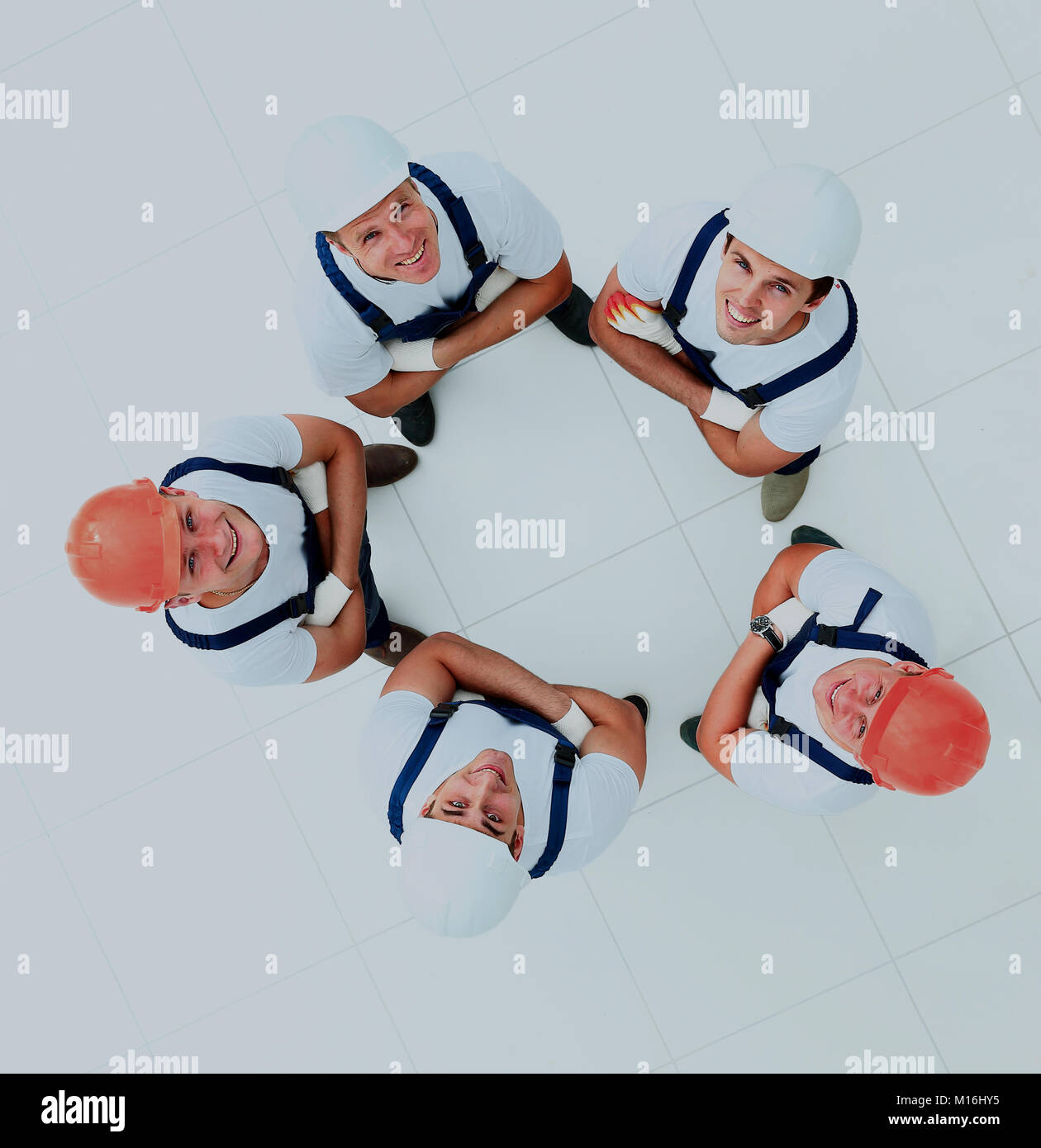 Large group of workers standing in circle Stock Photo - Alamy