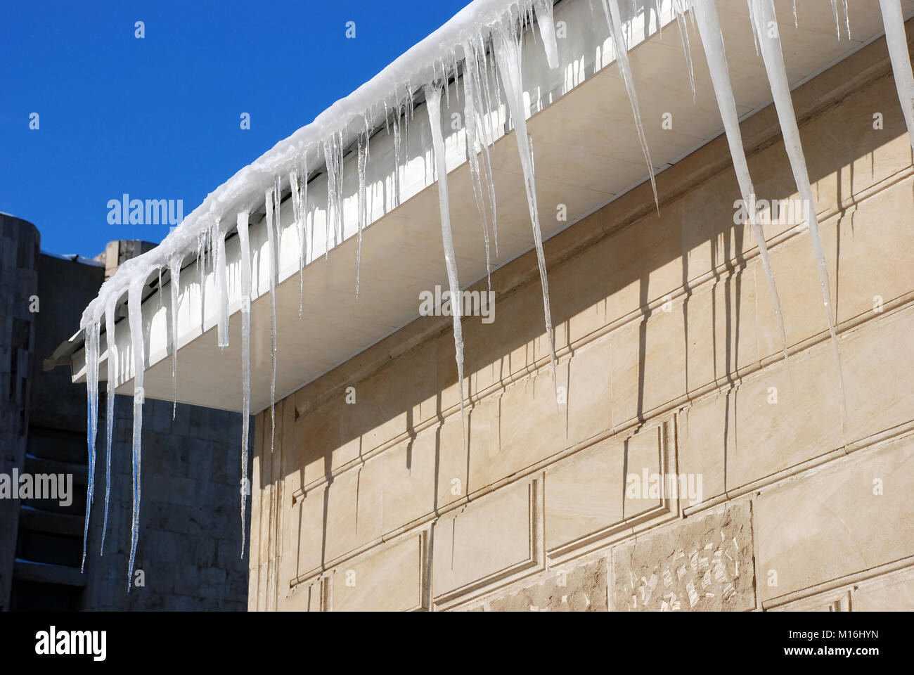frozen window ice pieces hanging from the rook ceiling in a brick ...