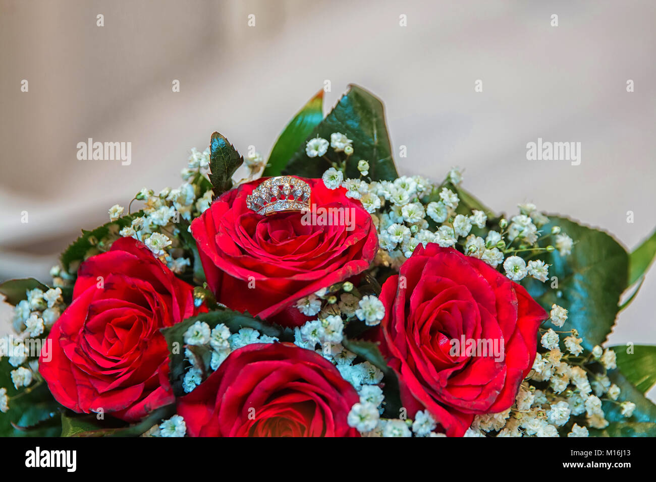 Rings on the red rose bouquet at the wedding . Wedding Ring in Rose ...
