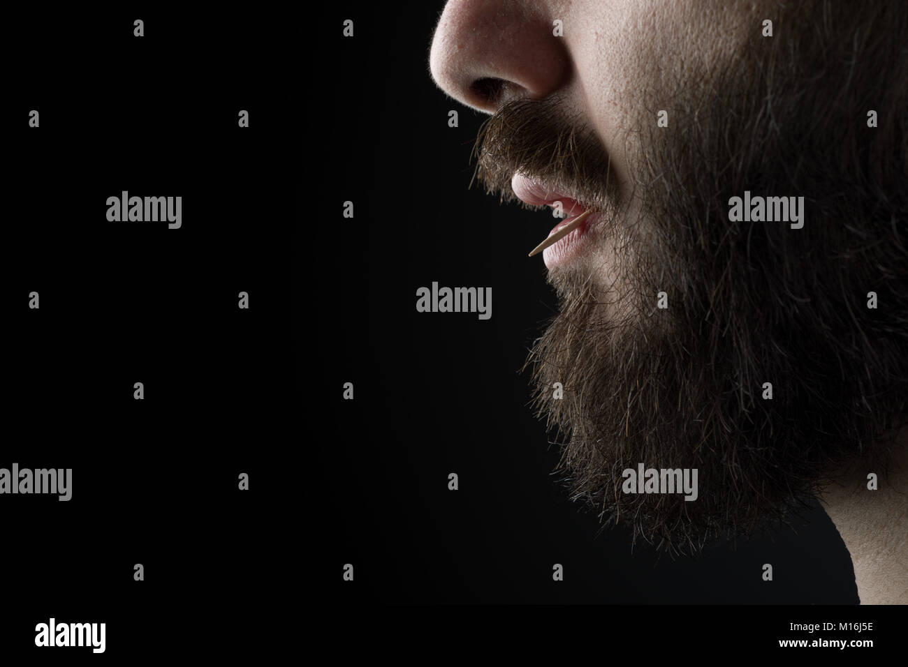 Man with toothpick in his mouth hi-res stock photography and images - Alamy