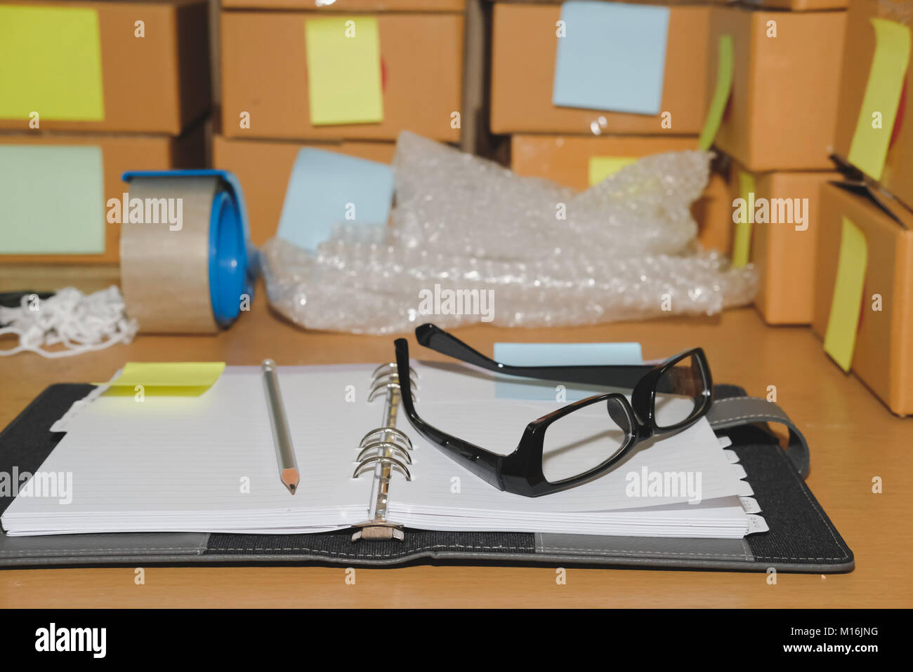 notebook, packing accessories at workplace of startup small business ...