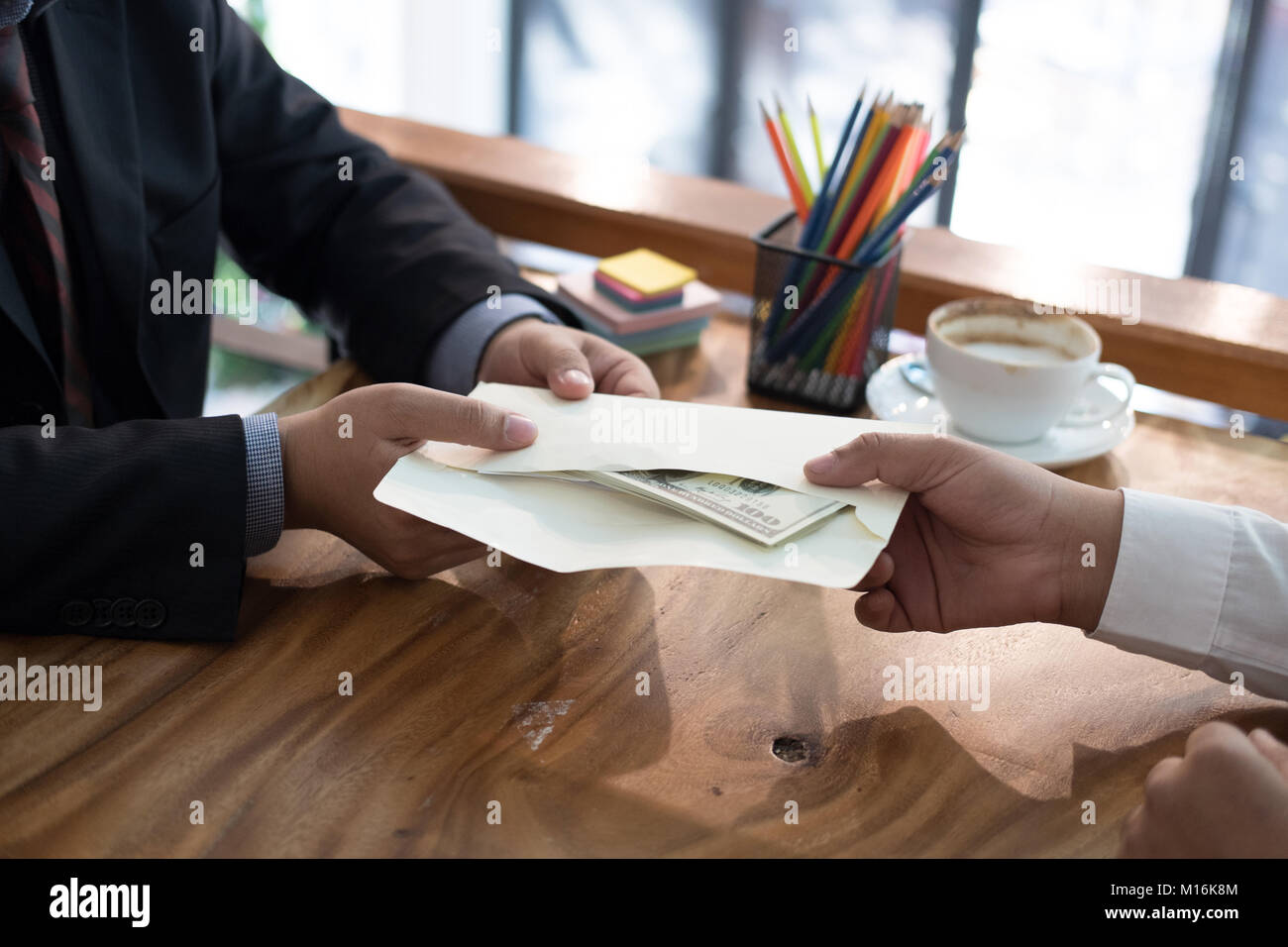 Businessman receiving envelope with money banknote. hand giving cash ...