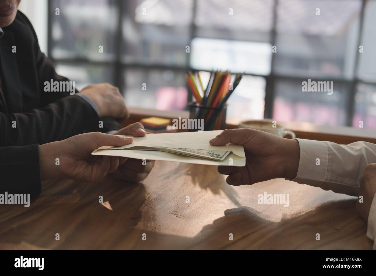 Businessman receiving envelope with money banknote. hand giving cash ...