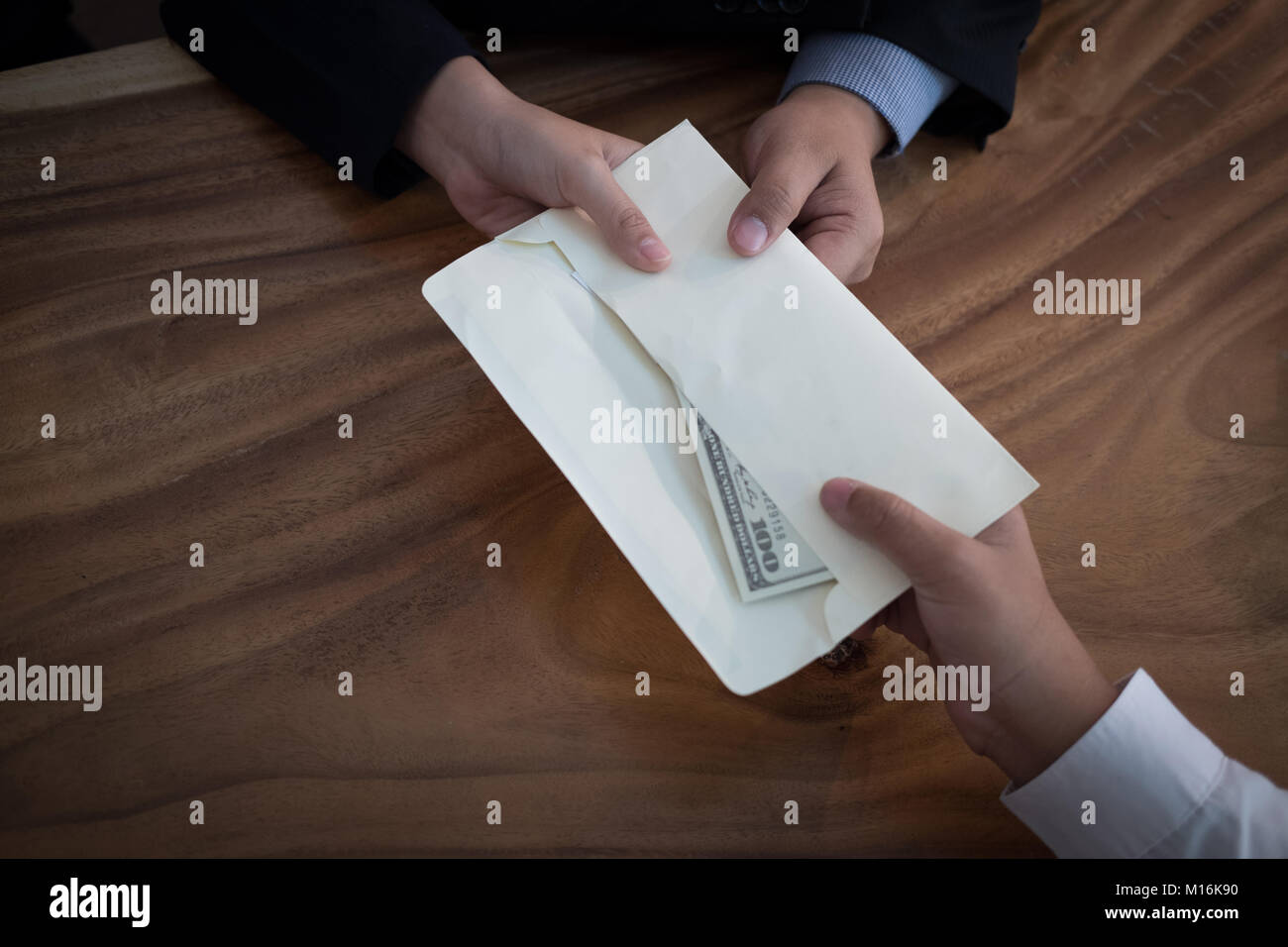 Businessman receiving envelope with money banknote. hand giving cash ...