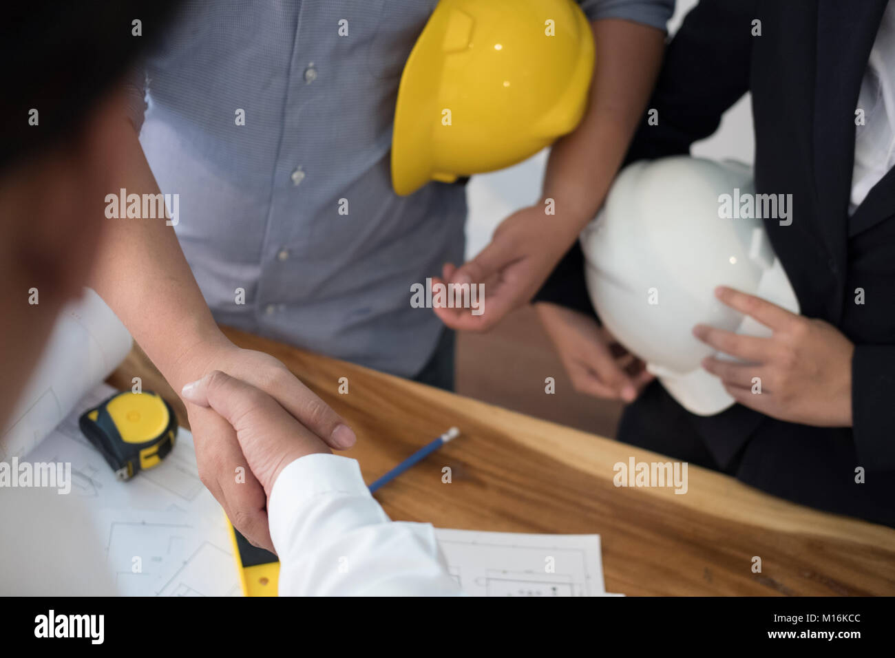 architect & customer shaking hands at workplace. Engineer handshaking ...