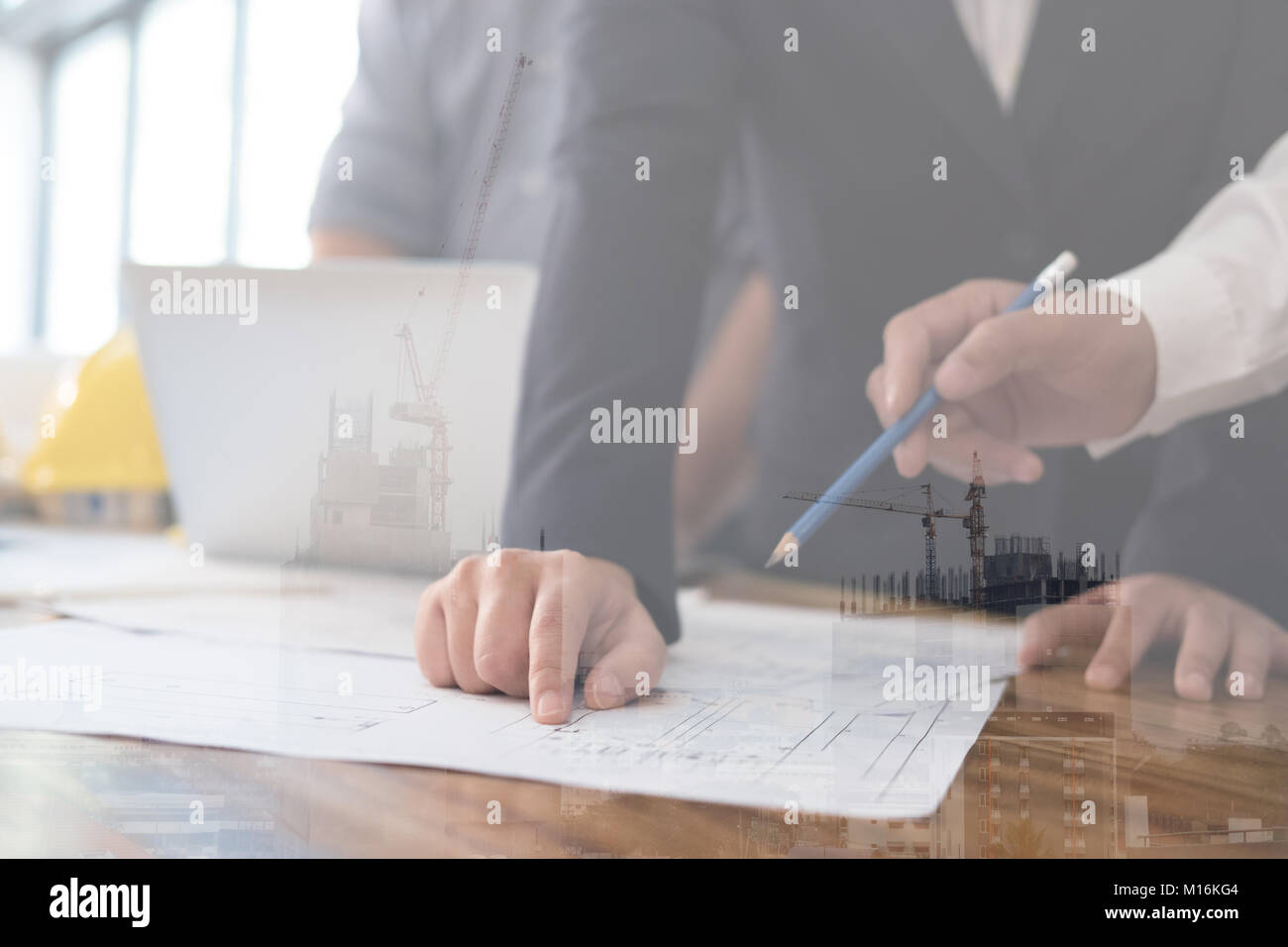 architect working on real estate project with partner at workplace ...