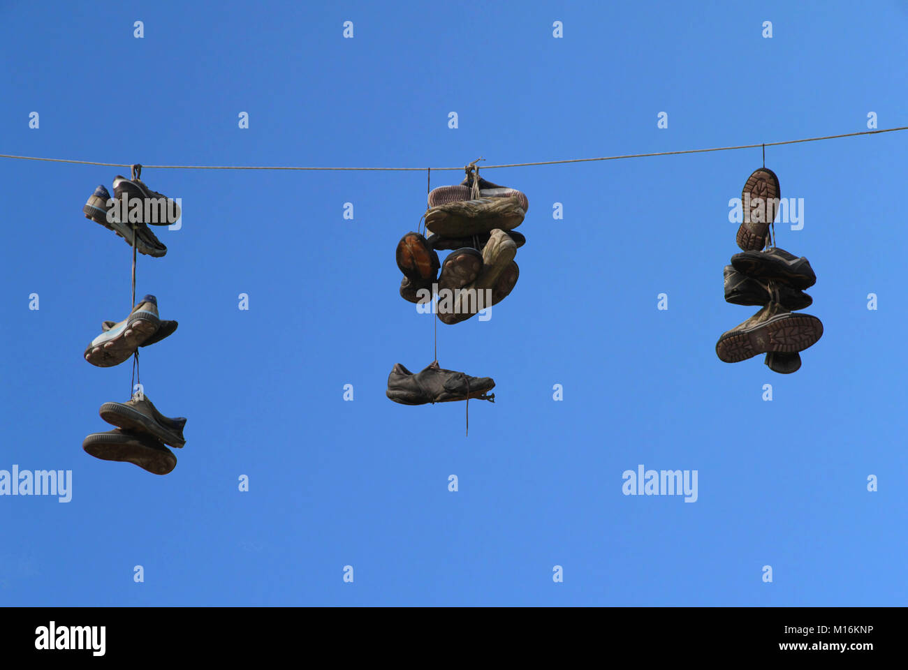 Old boots hang on a cord Stock Photo - Alamy