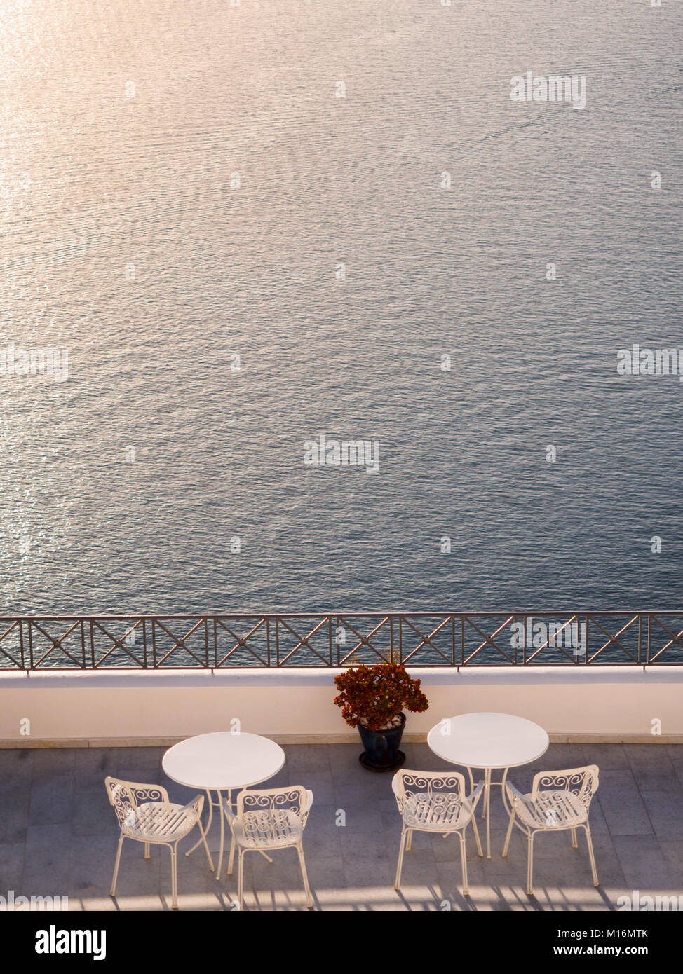 Balcony with tables and sea view in Santorini, Greece Stock Photo - Alamy