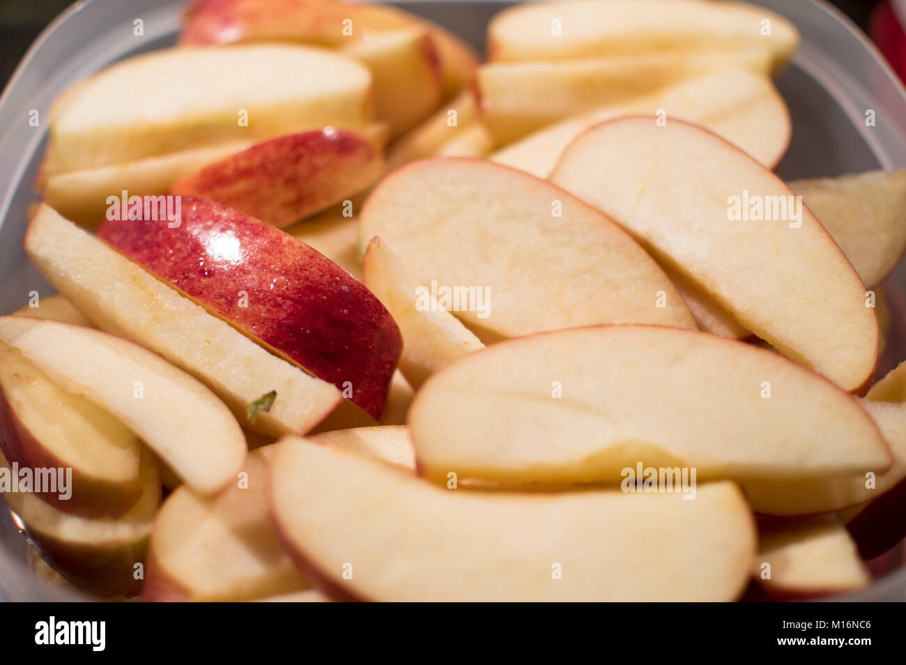 Apple slices in plastic container Stock Photo - Alamy