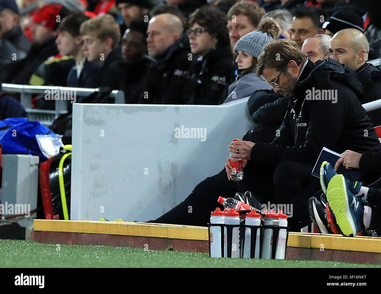 Liverpool manager Jurgen Klopp (right) appears dejected in the dugout ...