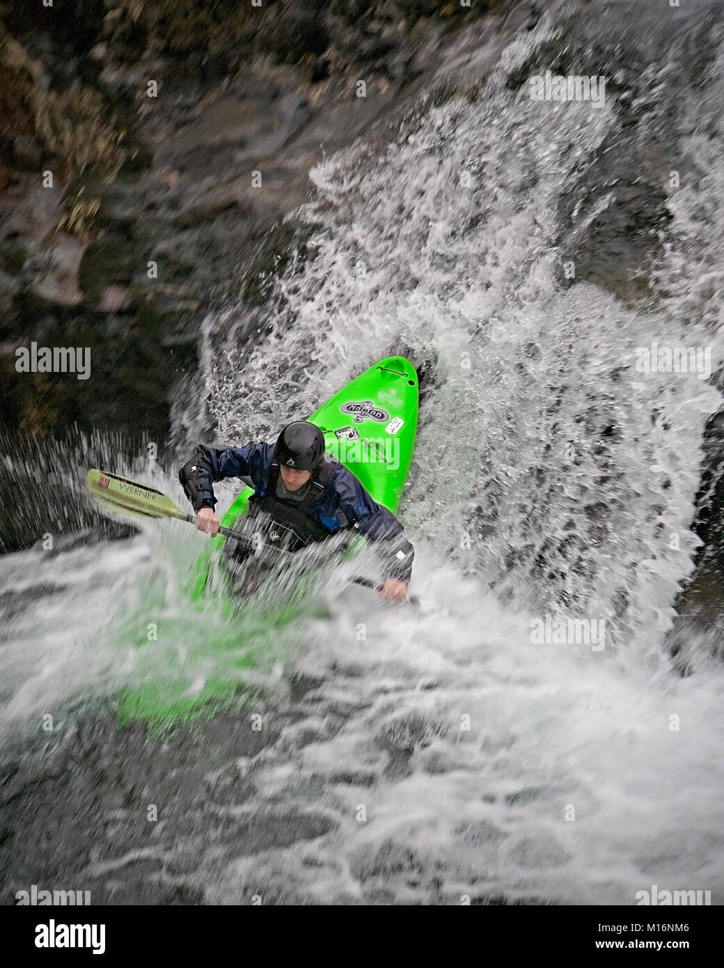 Canoeist plunging over a small waterfall with rocks Stock Photo - Alamy