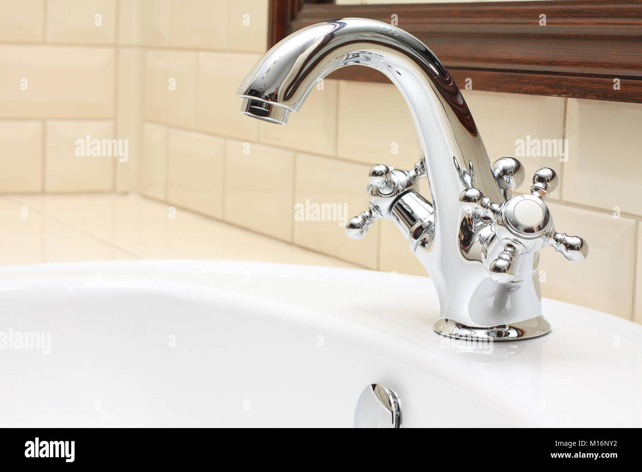 Bathroom close-up - sink, faucet and tile Stock Photo - Alamy