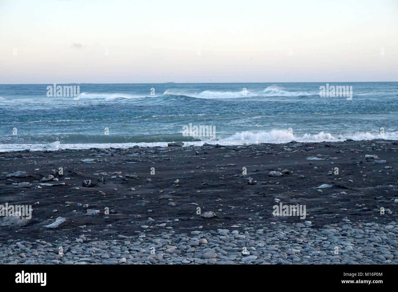 Ice washing up on the volcanic black sand beach near the Jökulsárlón ...