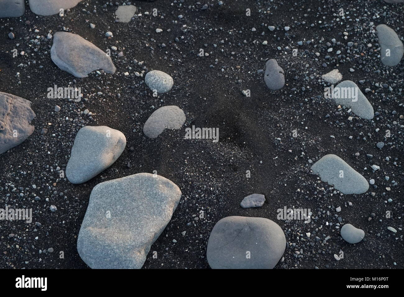 Stones on the volcanic black sand beach near the Jökulsárlón glacier ...