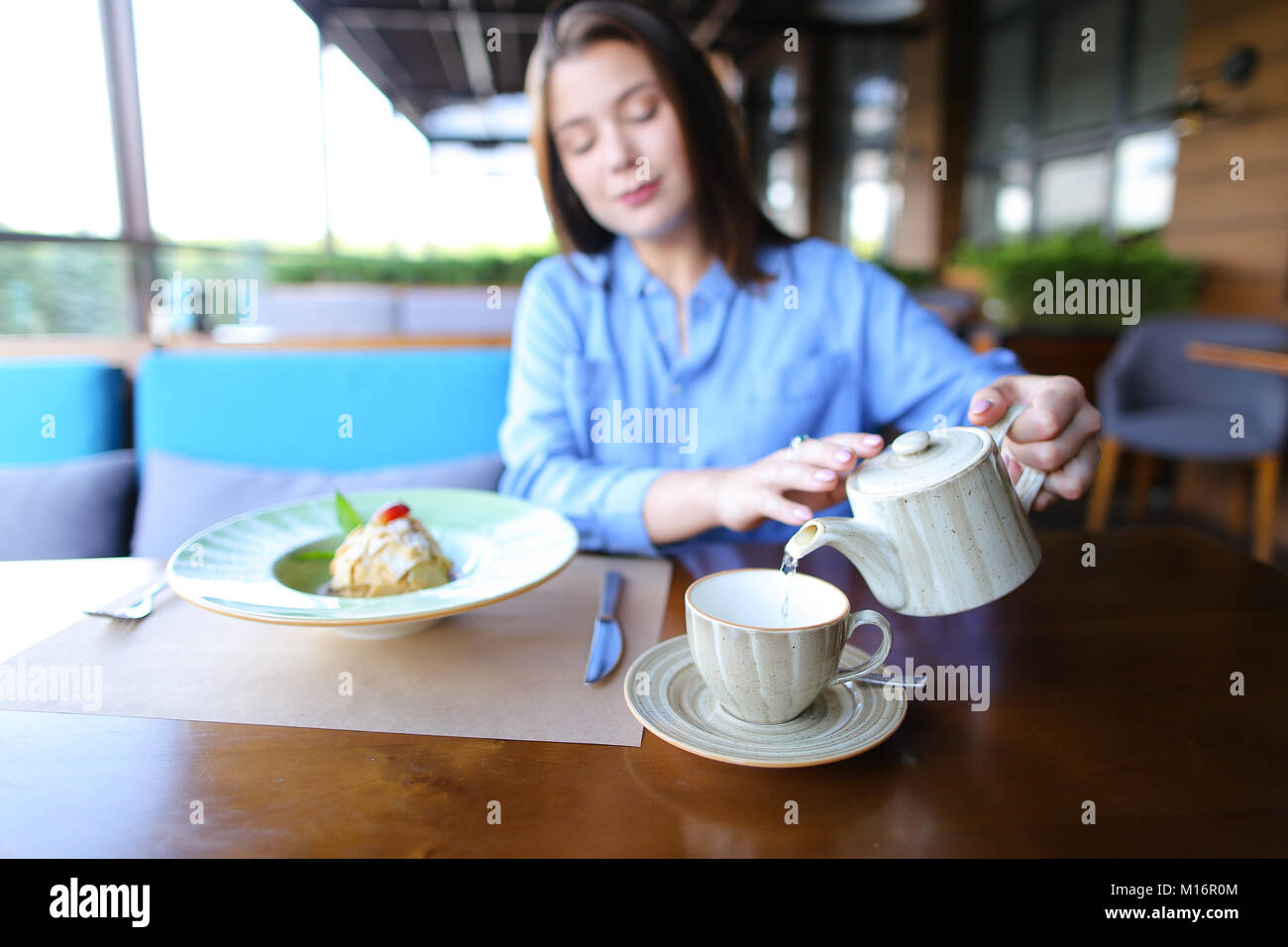 Charming restaurant customer pouring water into cup Stock Photo - Alamy