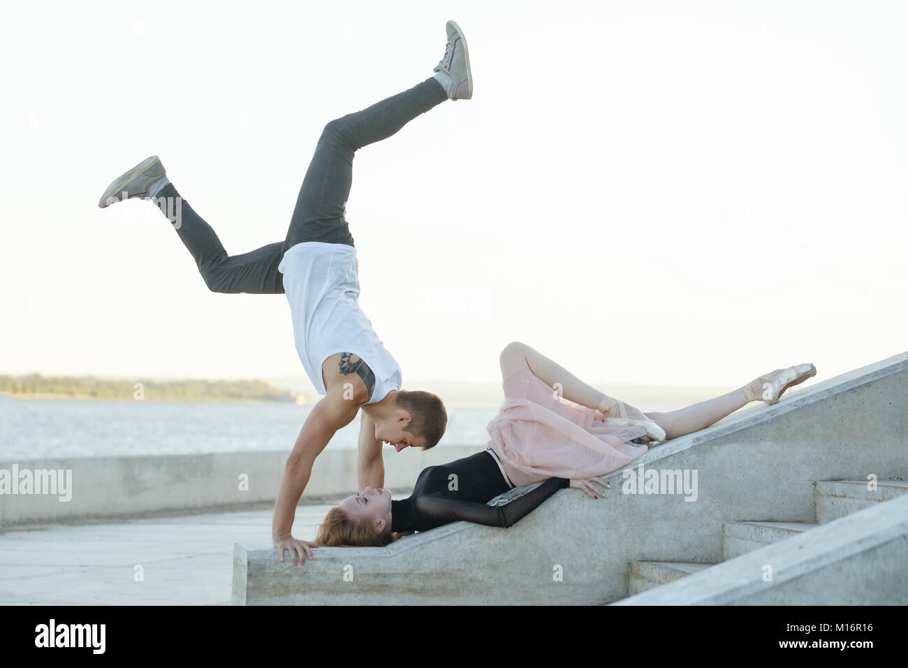 Slender ballerina dances with a modern dancer. Dating lovers. Passion ...