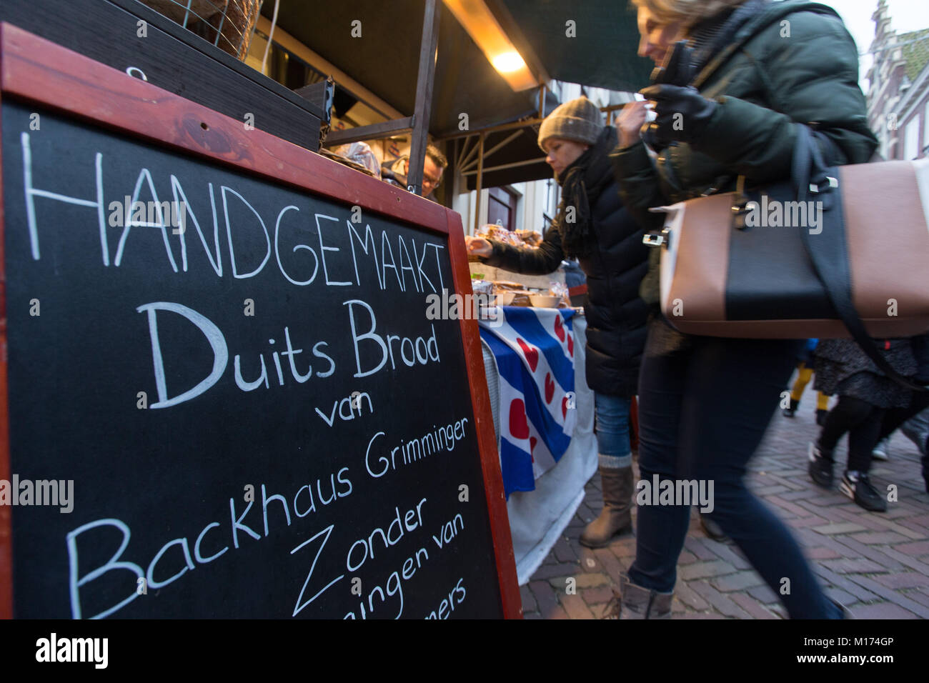 People tasting German bread ("Duits Brood") at a stall in Leeuwarden ...