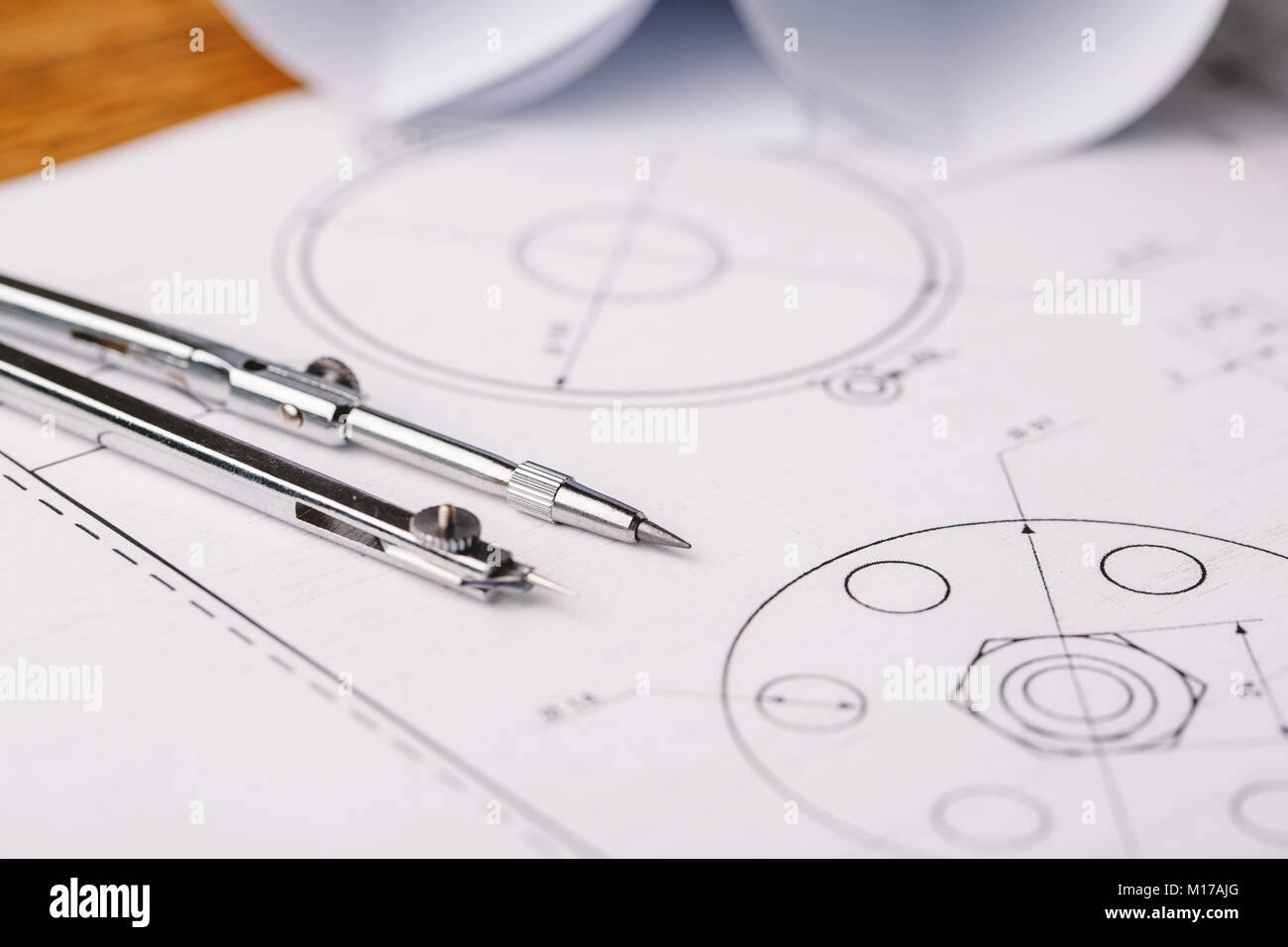 rolls of blueprints, drawing compass and graphical architectural plan ...