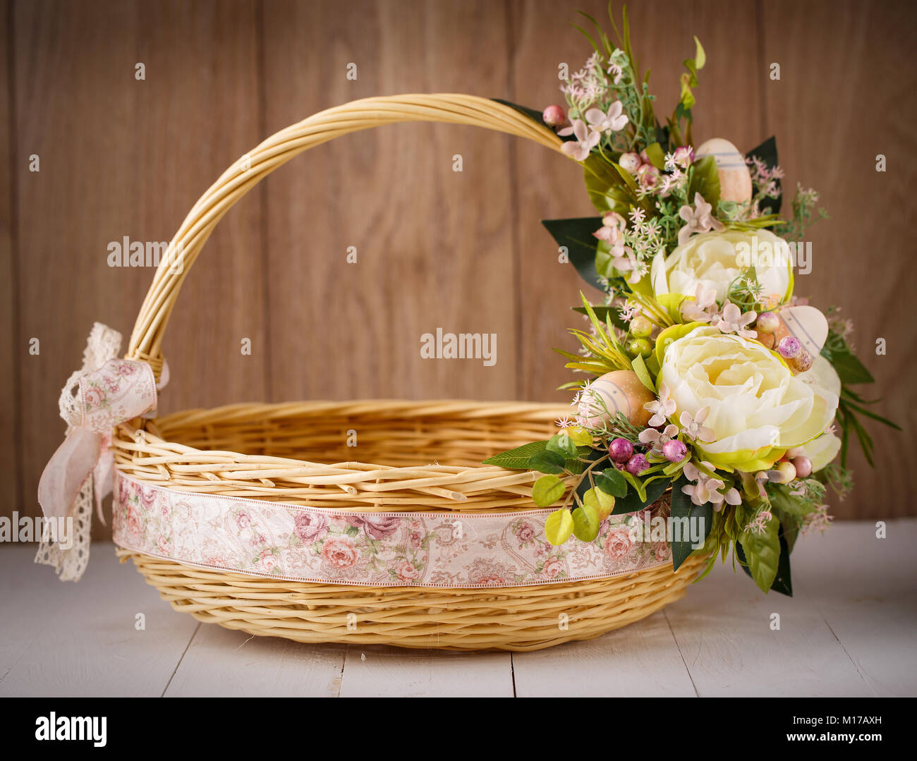 Basket decorated handmade. Festive basket decorated with flowers on ...