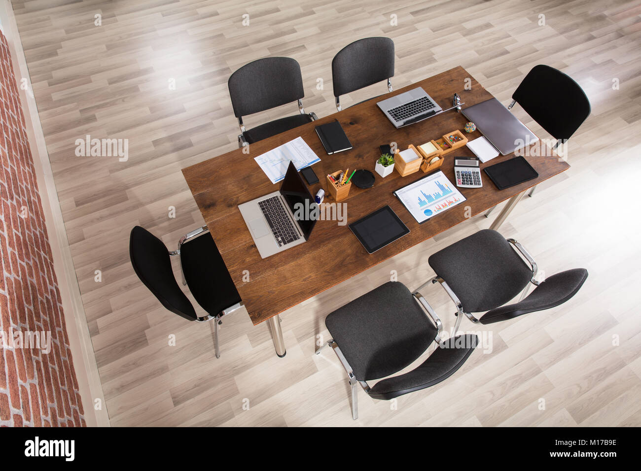 Elevated View Of Office Desk With Laptop And Graph Stock Photo - Alamy