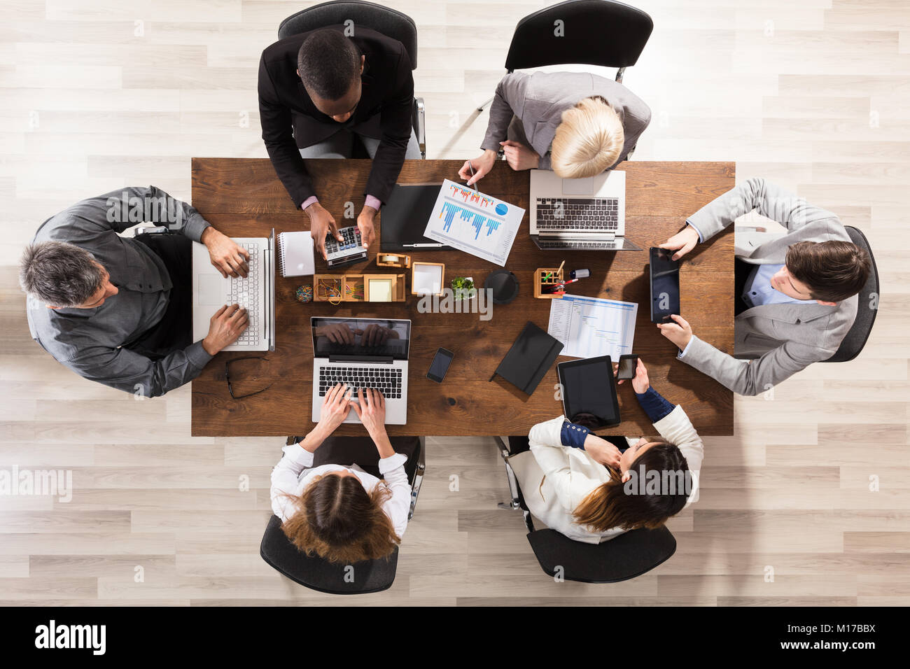 Overhead View Of Diverse Businesspeople Working At Workplace In Office ...