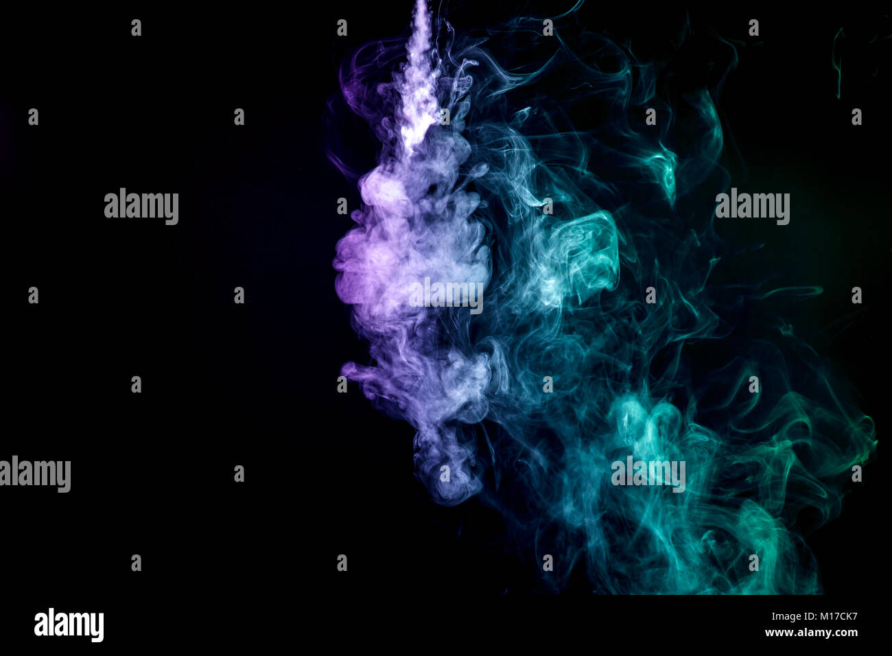 Dense multicolored smoke of purple and green colors on a black isolated ...
