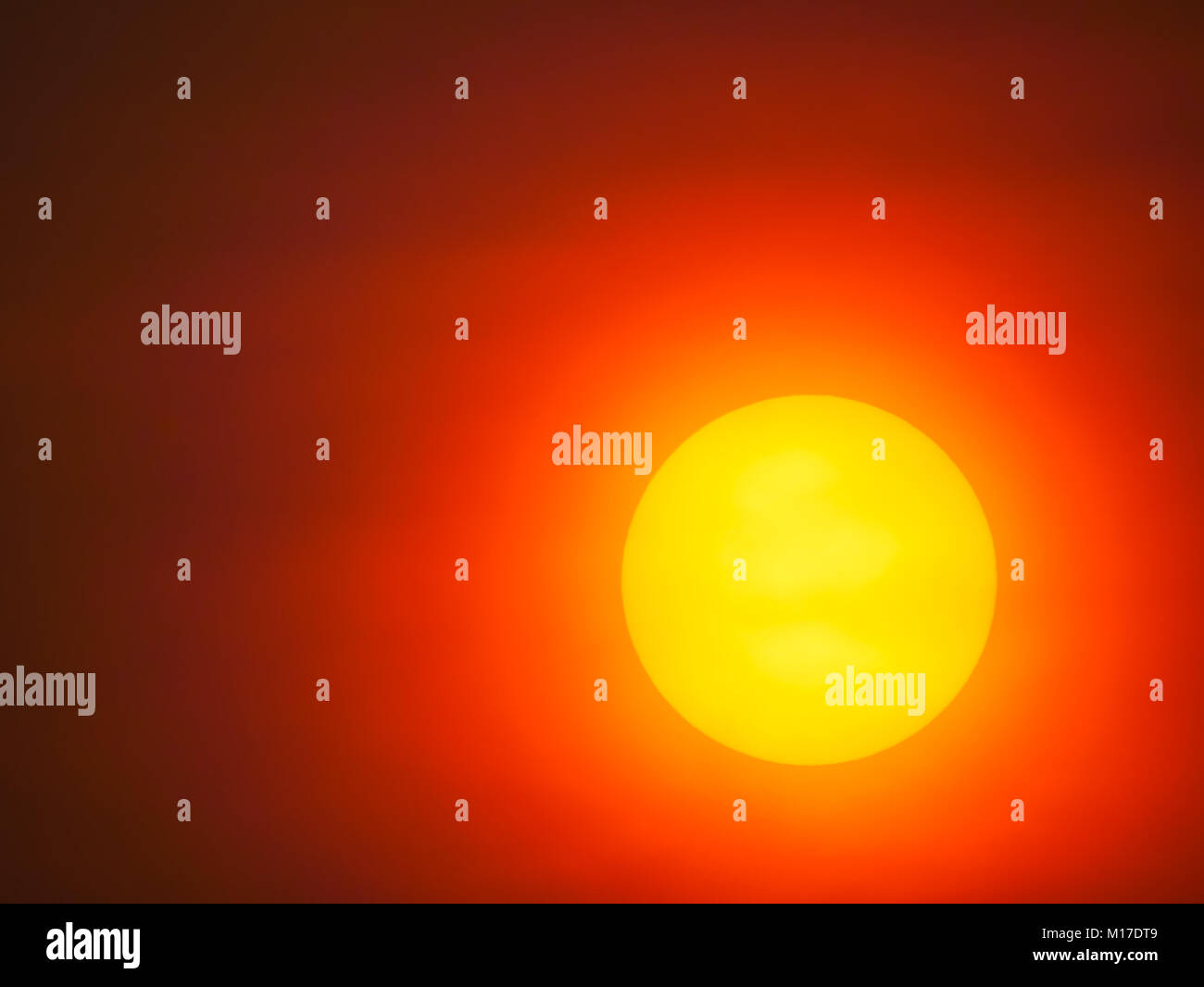 Closeup big yellow sunset on red sky background Stock Photo - Alamy