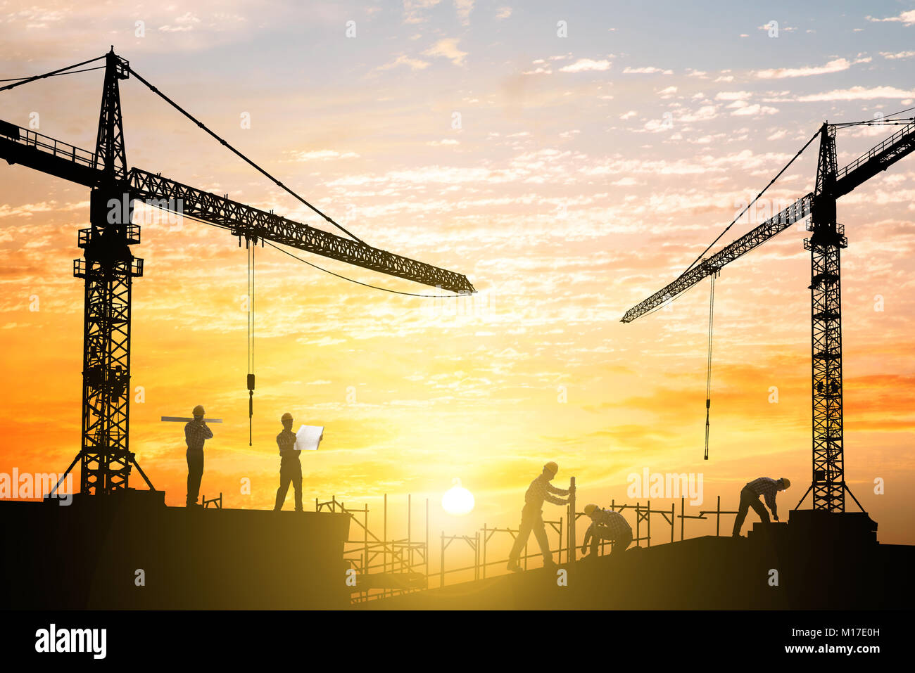 Silhouette Of Engineers Working At Construction Site During Sunset ...