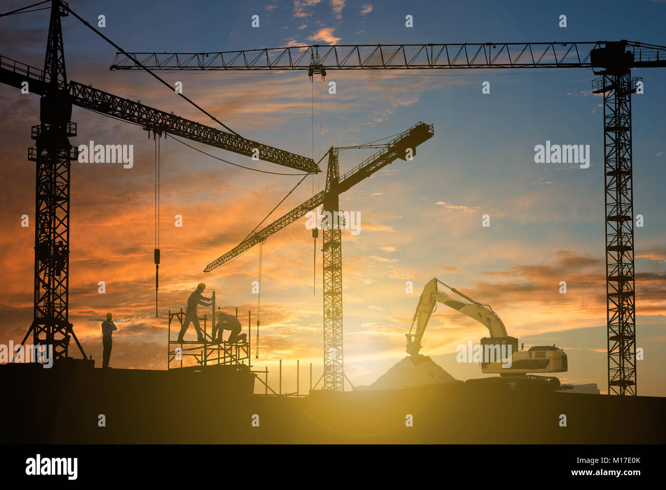 People At Construction Site With Cranes During Sunset Stock Photo - Alamy