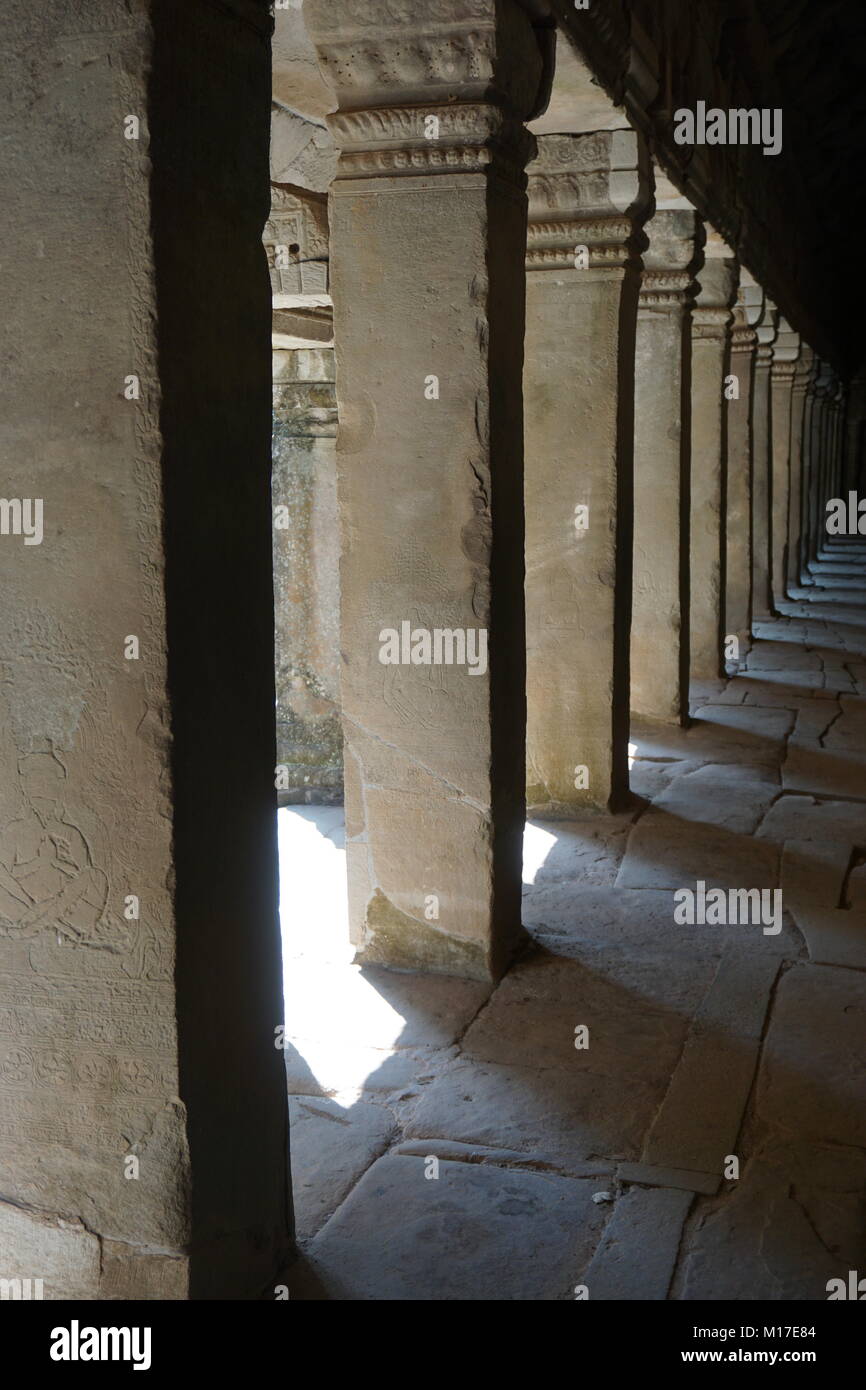 Pillars inside of an ancient temple, with the afternoon light streaming ...