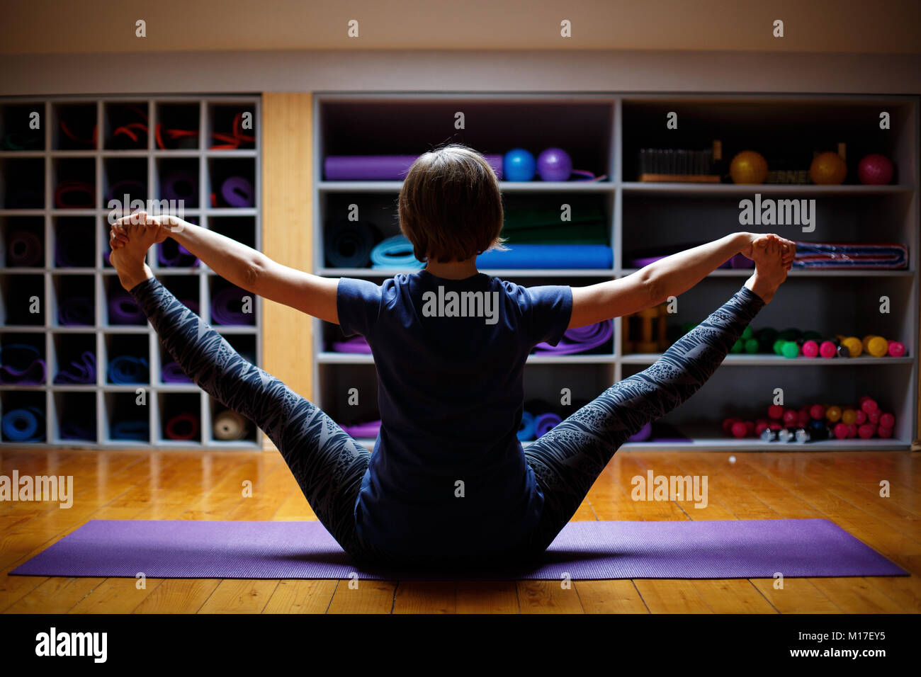 Fitness girl doing yoga exercises in the gym Stock Photo - Alamy