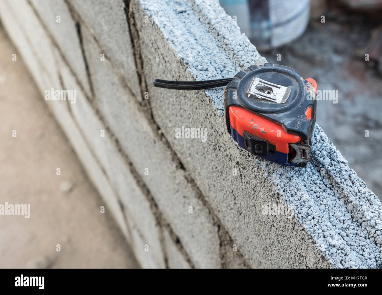 Old measuring tape on the block wall of the unfinished house Stock ...