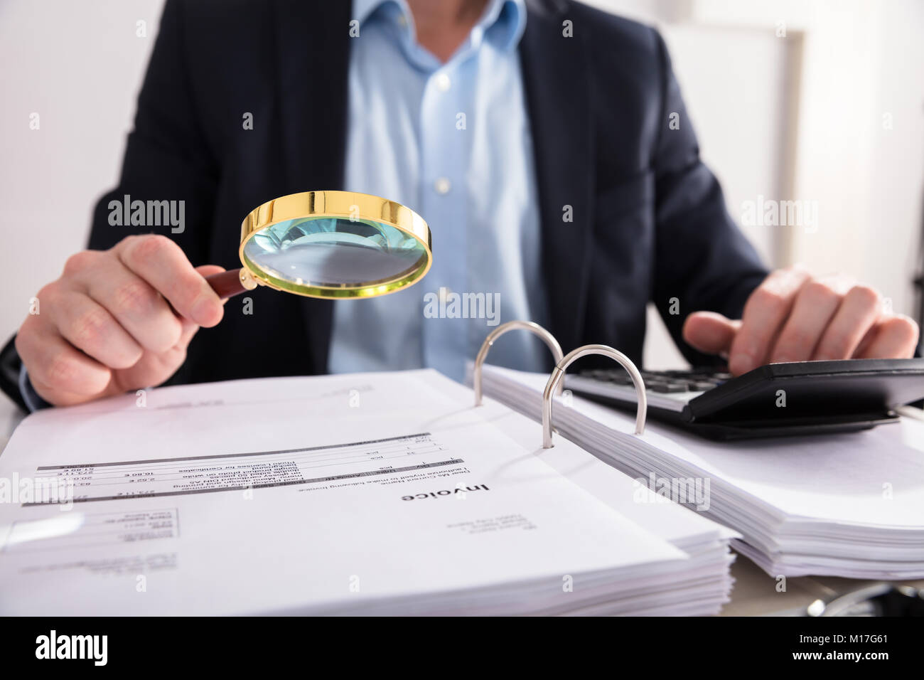 Close-up Of A Businessperson's Hand Checking Invoice Through Magnifying ...