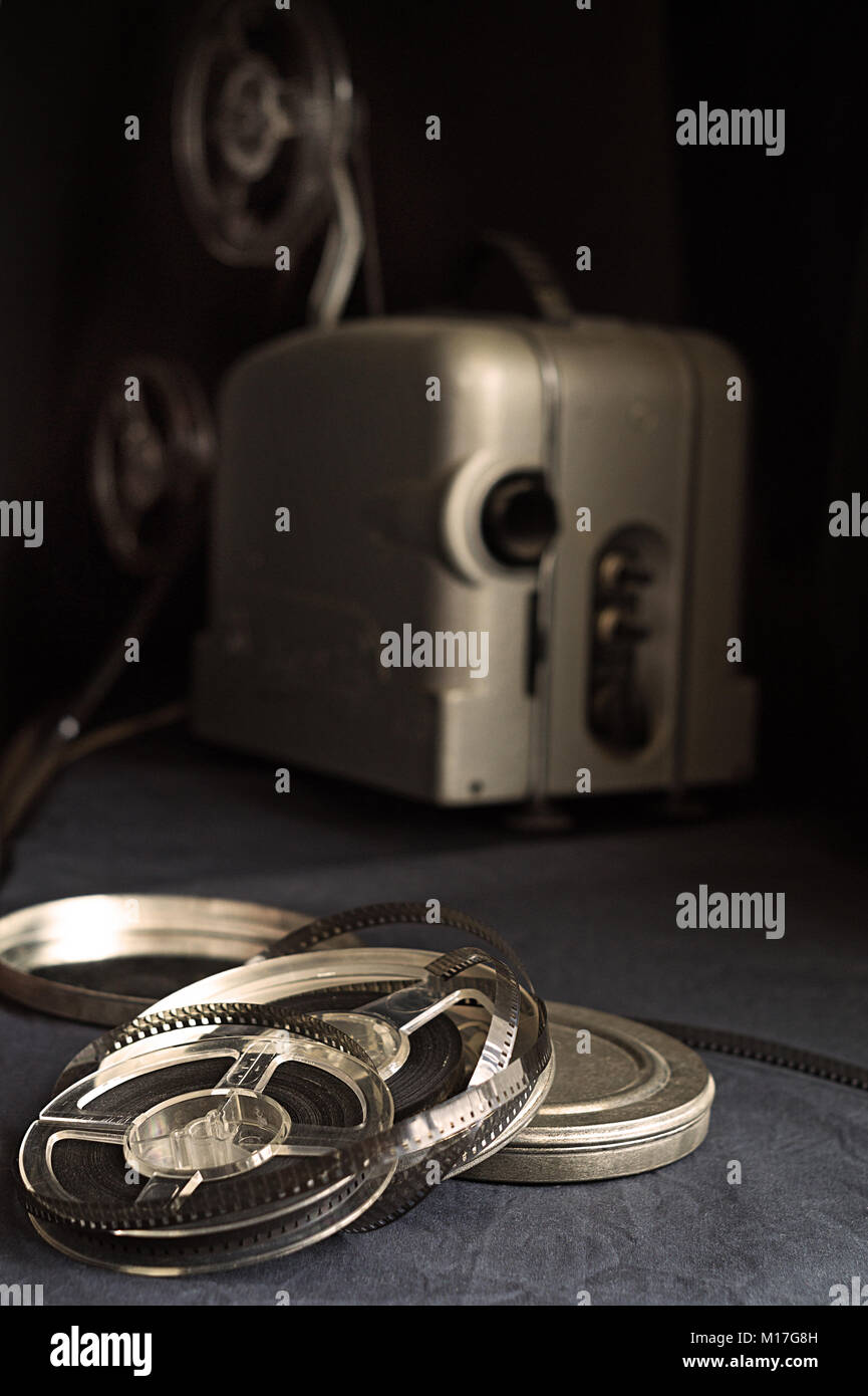 Old cinema projector and cassettes in dark Stock Photo - Alamy